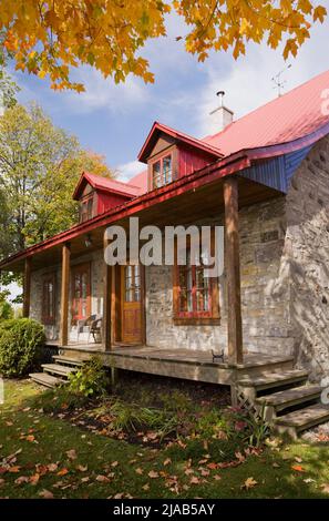 Old circa 1786 Canadiana cottage style fieldstone home facade with red ...