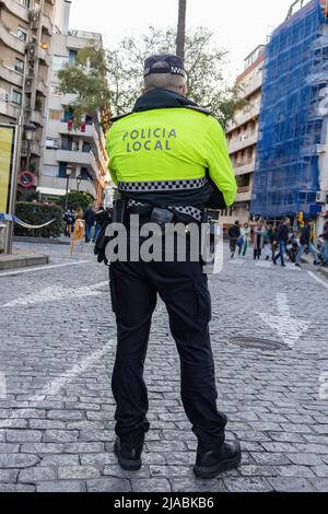 Spanish policeman of the Policia Local in a small alley in Vejer de la ...