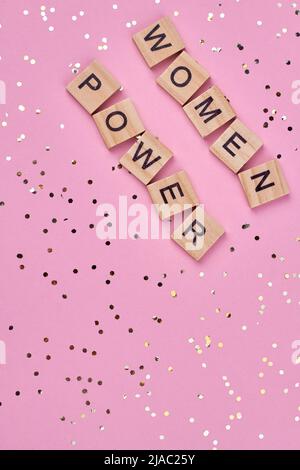 Women power inscription on wooden cubes against color background ...