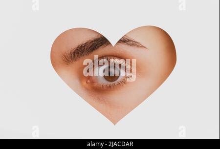 Eye through paper. Ophthalmology. Closeup eyes. Heart shaped hole Stock ...