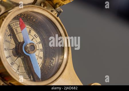 Detail of an antique maritime bronze solar compass in black and white ...