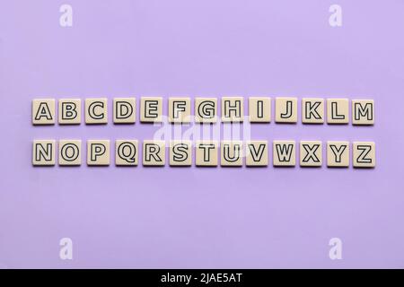 Different letters on lilac background. Alphabet concept Stock Photo - Alamy