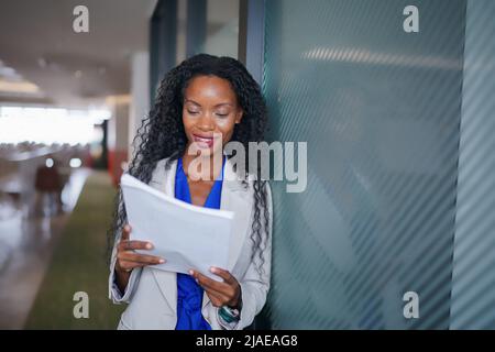 oung concentrated businesswoman holding pen filling document or tax ...