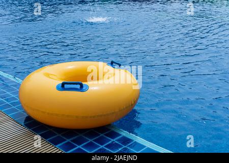 Swim ring with wave pattern in the empty clear pool. Swimming pool top ...
