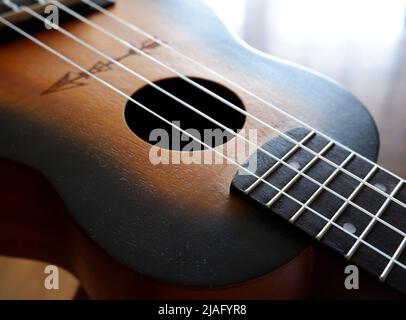 Ukulele soundboard, strings and fretboard close up Stock Photo - Alamy