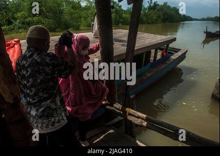 Residents are seen riding water transportation at the Batang Buluh pier ...