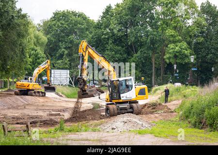Excavators at work restoring canalized streamlet back to meandering ...