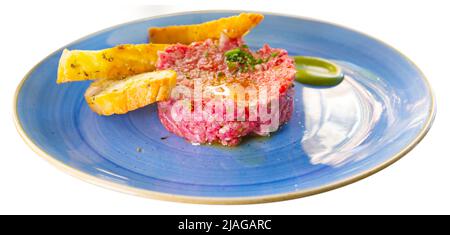 Image of delicious veal steak tartar served at plate with fried bread ...
