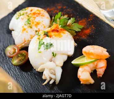 Roasted sepia served with shrimps Stock Photo - Alamy
