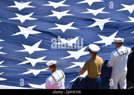 United States military personnel unroll a 100-foot American Flag during ...