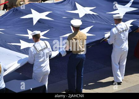 United States military personnel unroll a 100-foot American Flag during ...