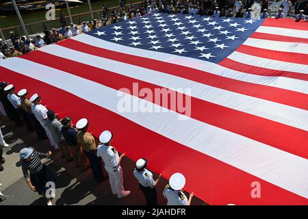 United States military personnel unroll a 100-foot American Flag during ...
