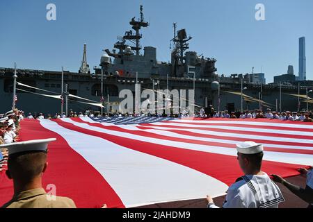 United States military personnel unroll a 100-foot American Flag during ...