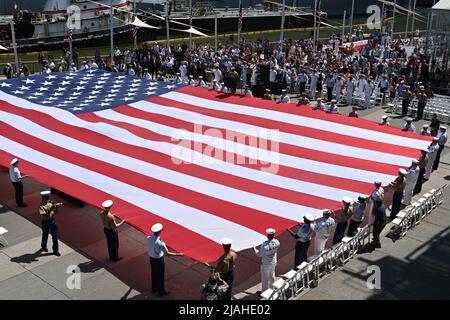 United States military personnel unroll a 100-foot American Flag during ...