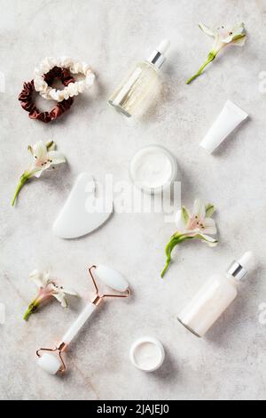 Set of massage roller and gua sha for face on blue background. Self ...