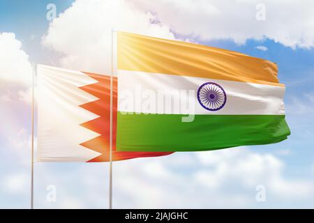 Bahrain flag and India flag waving together on blue sky, two country ...