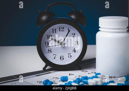 Time to take your medicine. Pill reminder. Tablets and alarm clock ...