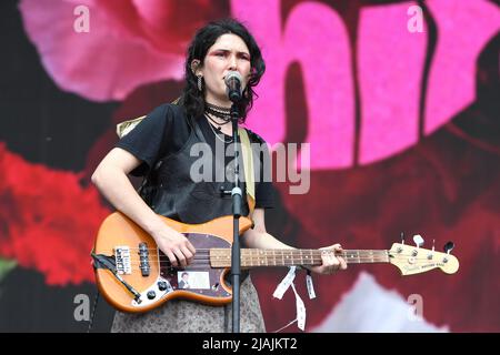 Bass guitarist and singer Ade Martin is shown performing on stage ...