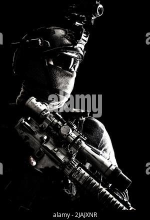 Sniper wearing face mask and helmet with thermal imager, holding rifle ...