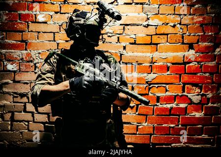 An elite soldier holding a shotgun against a brick wall, wearing face ...