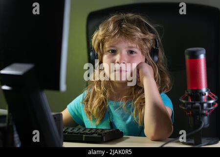 Child with computer late at night. Neon blue light. Little hacker ...