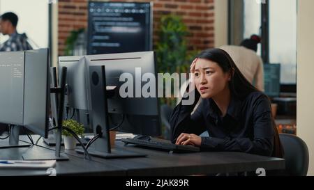 Programer writing algorithm focused on compiling source code sitting at ...