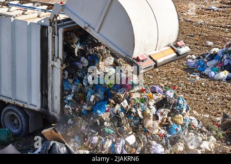 Truck unloading garbage on an open air dump. Waste recycling Stock ...