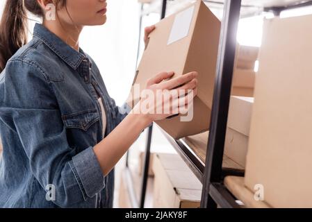 Cropped view of seller holding shipping label in online web store Stock ...