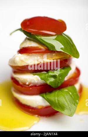 Stacked insalada caprese on white Stock Photo - Alamy