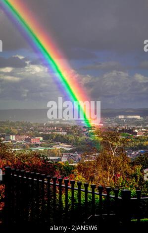 A bright rainbow over the city in the fall Stock Photo - Alamy