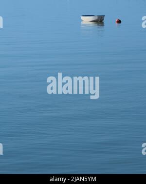 Dinghy on calm water Stock Photo - Alamy