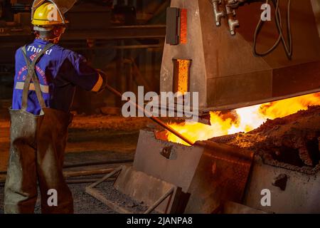 Man with long handle crucible, First Quantum Minerals copper smelter ...