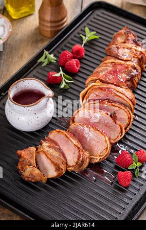 Bacon wrapped pork tenderloin with raspberry vinaigrette Stock Photo ...