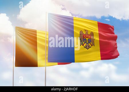 Sunny blue sky and flags of belgium and guinea Stock Photo - Alamy