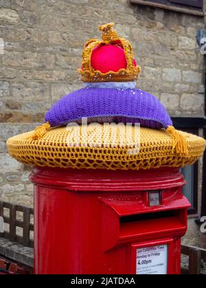 Royal Mail postbox with a knitted topper featuring a royal crown to ...