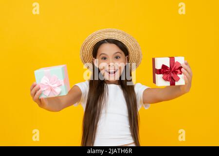 surprised teen girl hold present box on yellow background Stock Photo ...