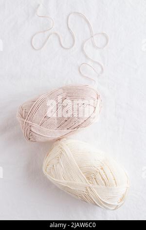 Needlework. Balls of cotton yarn pastel colors on a white table, copy ...