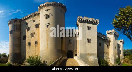 The towers and massive walls of Tarascon Castle with the moat around it ...