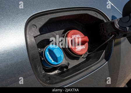 Fuel filler flap open with red diesel cap and blue adblue, the fuel ...