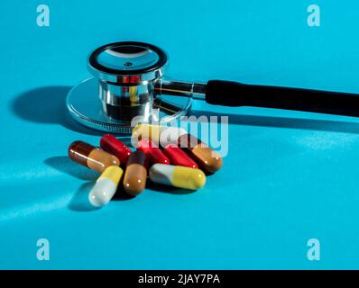 Multicolored medical capsules on a blue background. High quality photo ...