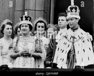 Still in their coronation robes of ermine and their crowns, King George ...