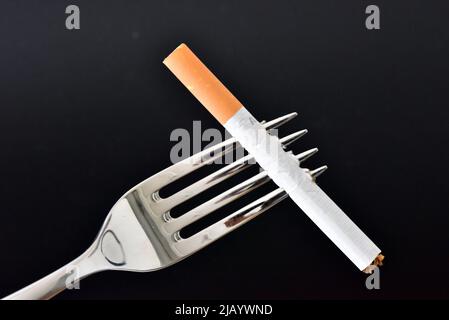 dinner fork with cigarette Stock Photo - Alamy
