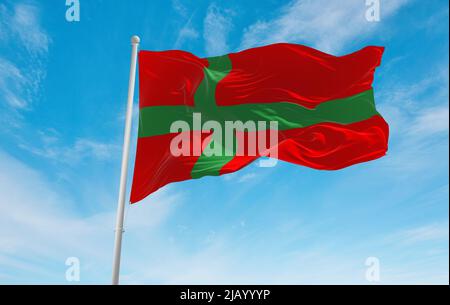 official flag of Bornholm , Denmark at cloudy sky background on sunset ...