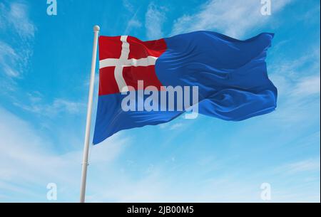 official flag of Danish blue ensign , Denmark at cloudy sky background ...