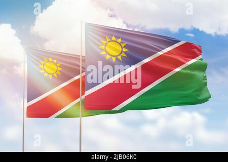 Sunny blue sky and flags of namibia and tunisia Stock Photo - Alamy