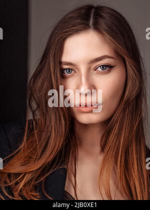 Close up portrait of joyless 20-25s woman standing alone. Face serious ...