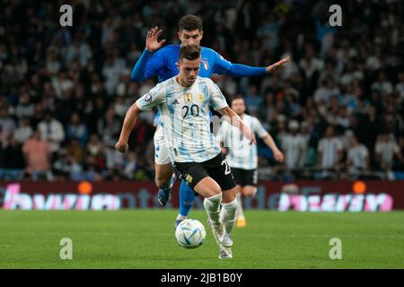 Giovani Lo Celso of Argentina runs with the ball and Giovanni Di Lorenzo of Italy puts the ...