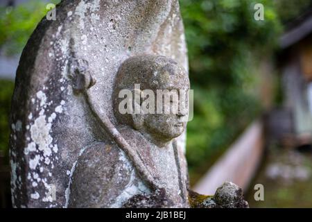 Closeup Unknown Japanese Jiro Statue in the woods Stock Photo - Alamy