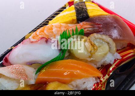 Pack of takeout Sushi. Maguro(Tuna), Tamago(Egg), Kai(Shellfish ...