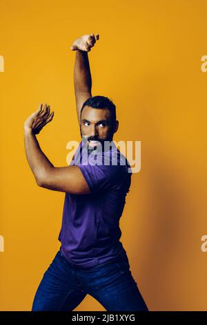 afro man posing on a yellow background while holding a soccer ball ...
